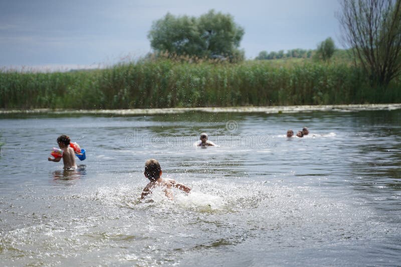 Children Have Fun on the Seashore, Splashes in All Directions. Happy ...