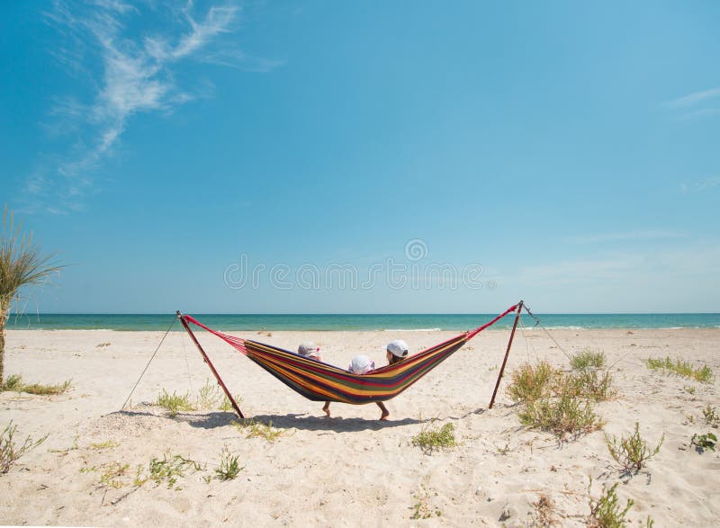 Children Have a Rest in a Hammock on a Sandy Seashore Stock Photo ...
