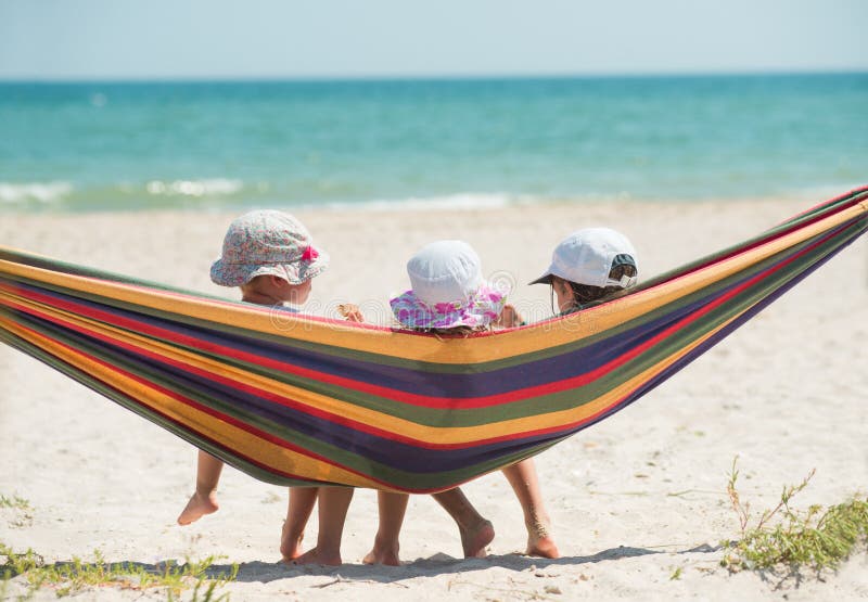 Children Have a Rest in a Hammock on a Sandy Seashore Stock Image ...