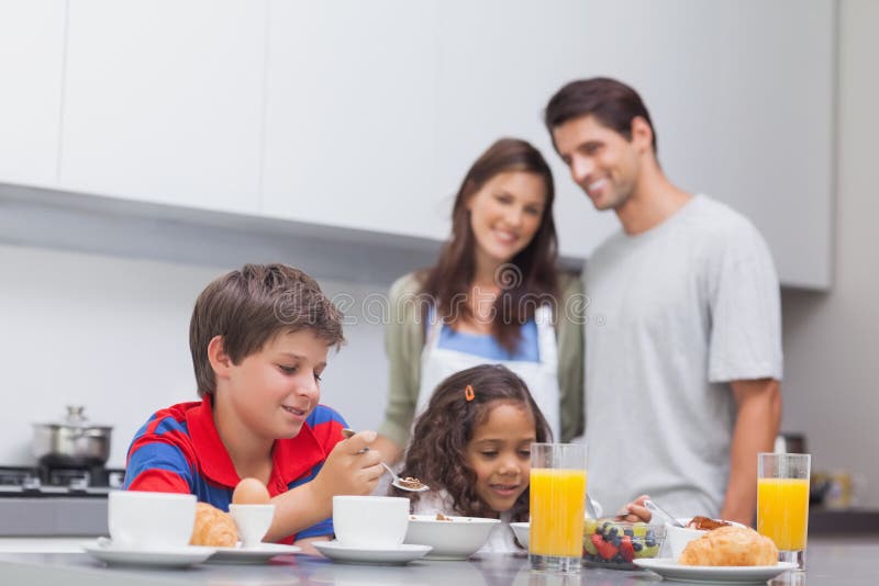 Children Having Breakfast in Kitchen Stock Image - Image of looking ...