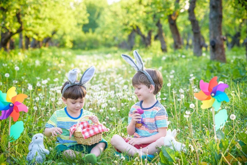 Children Having Fun and Playing with Easter Eggs. Two Cheerful Boys Sit ...