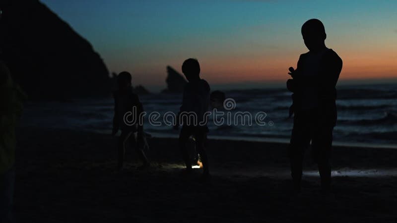 Kids Playing with Flashlights on Beach at Sunset Stock Footage - Video ...