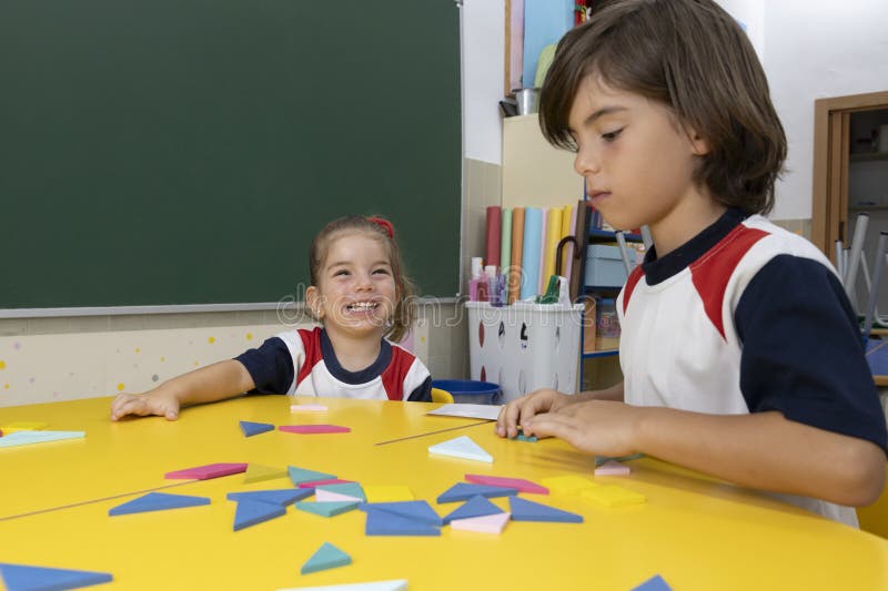 Children Having Fun in the School Making a Puzzle. Stock Photo - Image ...