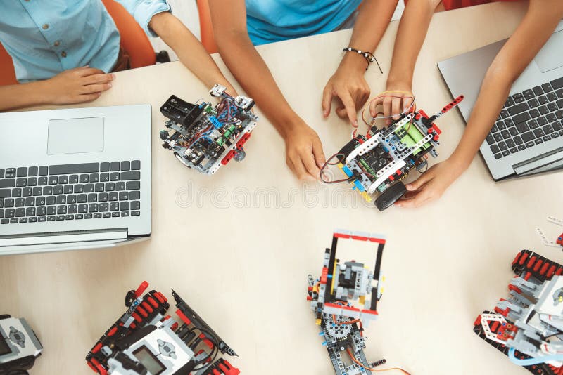 Robotics. Children Sitting Having Class Working on Robots Using Laptop ...