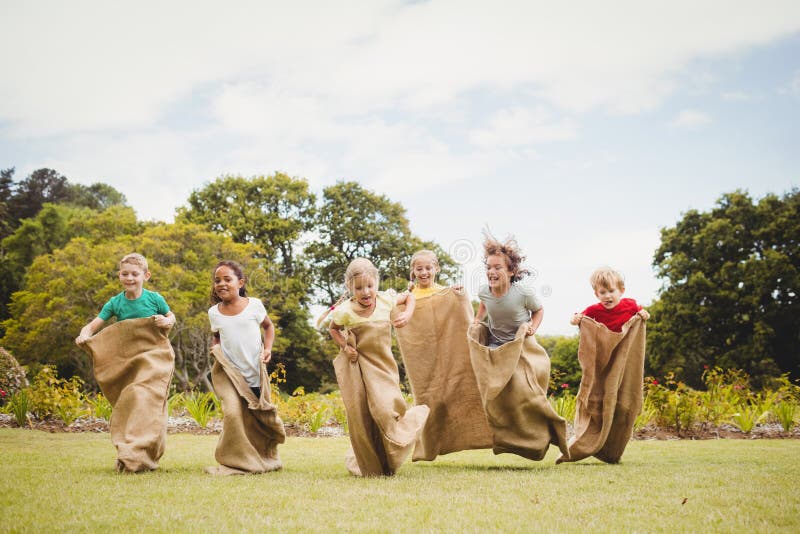 Group of Children Competing at Sack Race Stock Photo - Image of nature ...