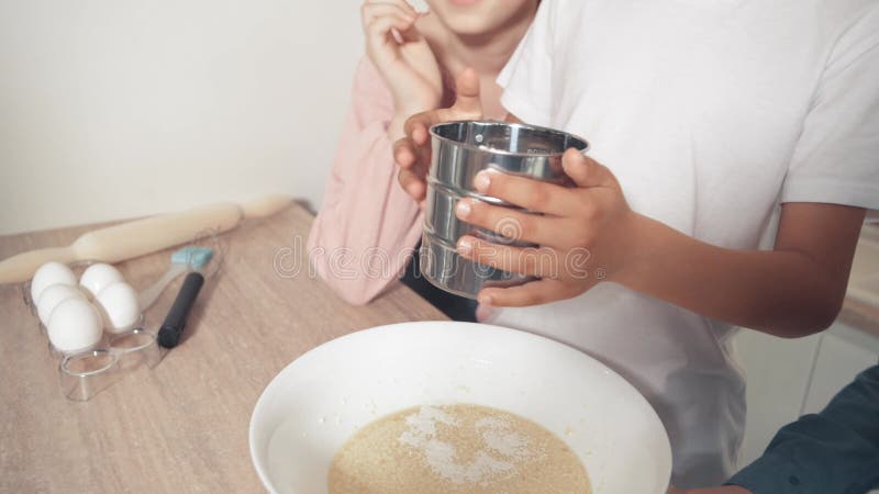 Children Help with Cooking in Kitchen. Adding Flour To the Dough. Stock ...