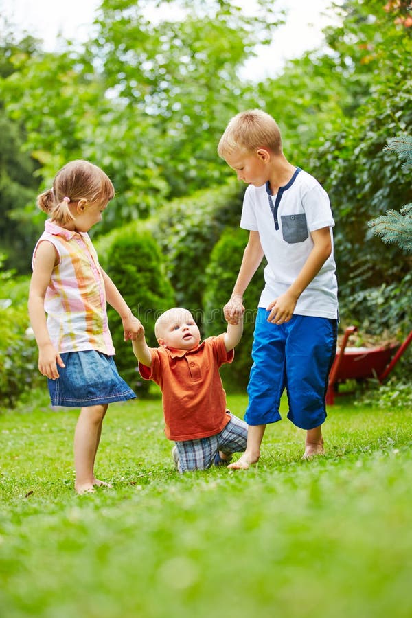 Children Helping Baby Learning To Walk Stock Photo - Image of crawl ...