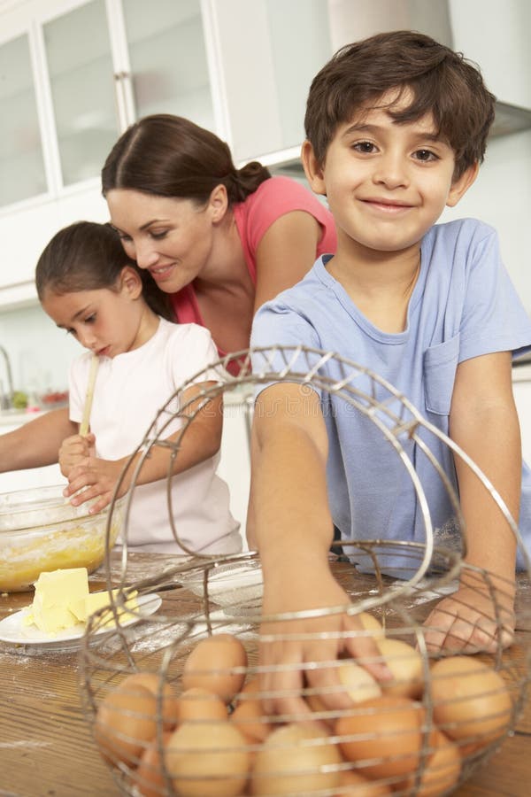 Children Helping Mother To Bake Cakes in Kitchen Stock Image - Image of ...