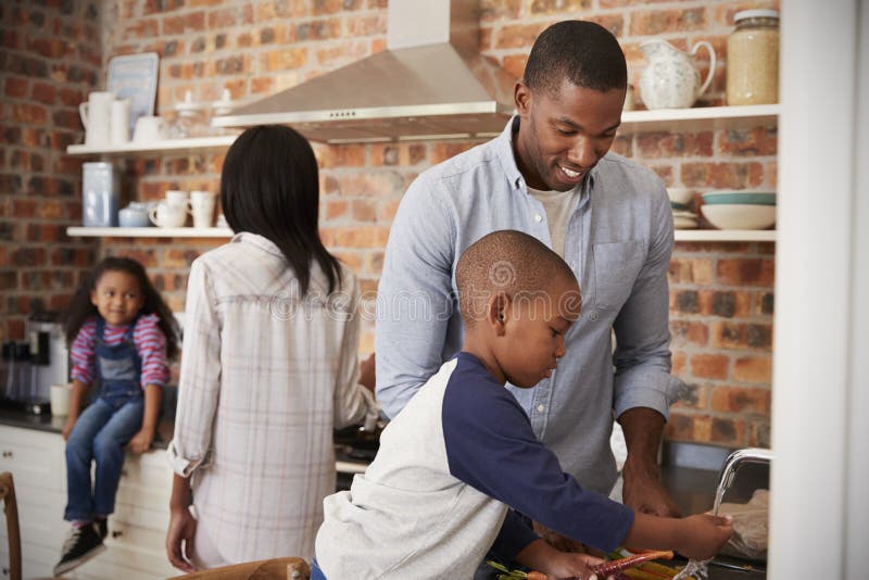 Children Helping Parents To Prepare Meal in Kitchen Stock Image - Image ...