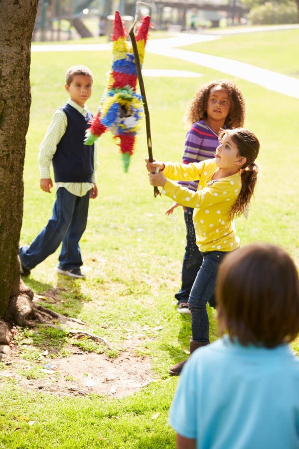 Children Hitting Pinata at Birthday Party Stock Photo - Image of ...
