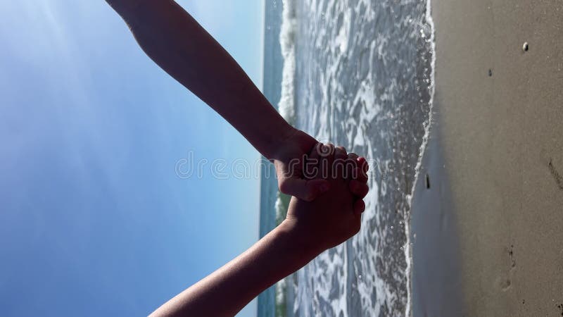 Children Holding and Releasing Hands by the Beach, Waves, Blue Sky ...