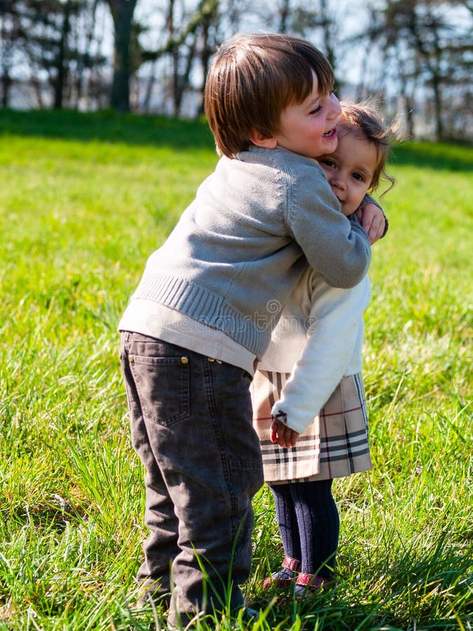 Children Hug Each Other in the Garden Dressed Casual Stock Image ...