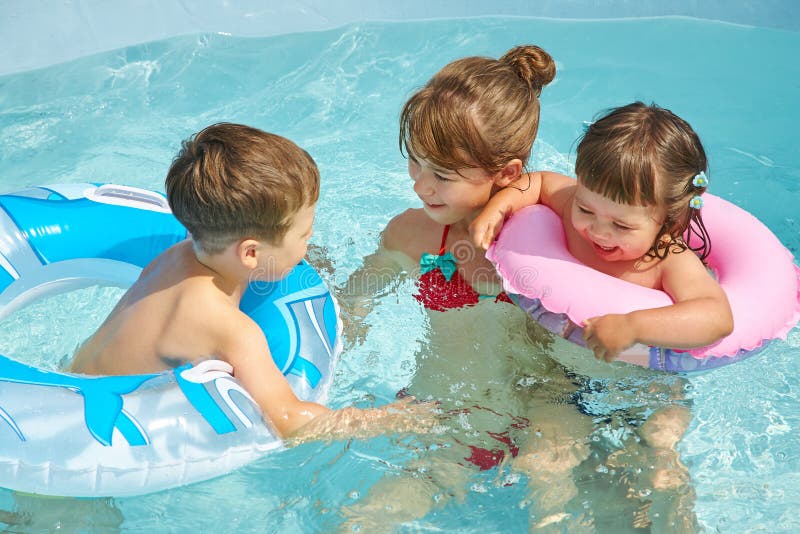 Children in Inflatable Swimming Circle Playing in Swimming Pool Stock ...