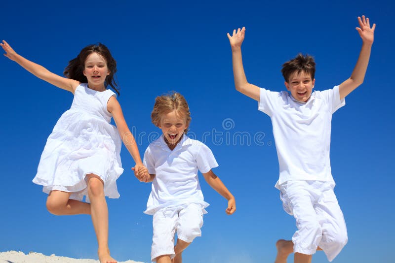 Kids jumping at the beach stock photo. Image of water - 2605082