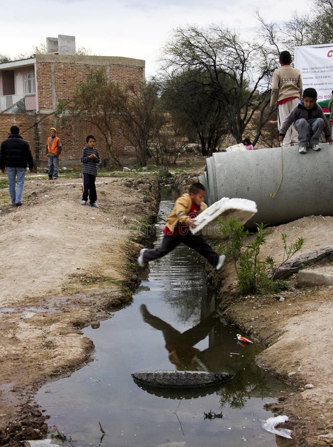Children Jumping Over a Ditch by Sewage Editorial Photo - Image of ...