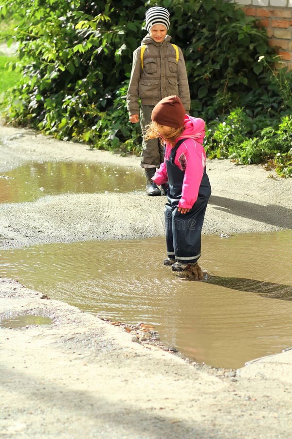 Children Jumping and Splashing in Muddy Puddles Stock Photo - Image of ...