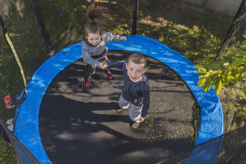 Children Jump on the Trampoline Stock Photo - Image of area, girl ...