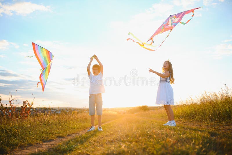 Children Launch a Kite in the Field at Sunset Stock Photo - Image of ...