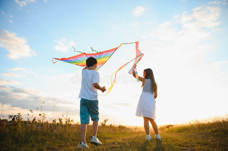 Children Launch a Kite in the Field at Sunset Stock Photo - Image of ...