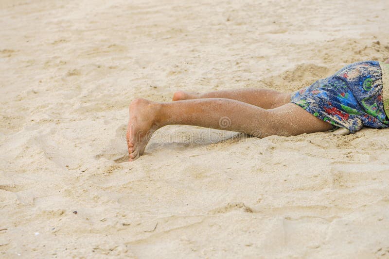 Children Legs when he Lay Down on the Beach Stock Image - Image of ...