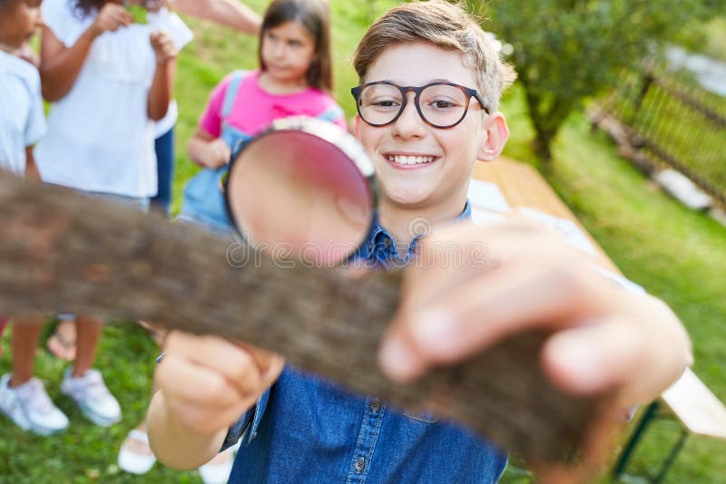 Children Look at Tree Bark through a Magnifying Glass Stock Image ...