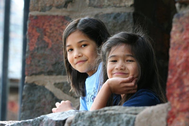 Children Looking Out Over Stone Wall Stock Photo - Image of family ...