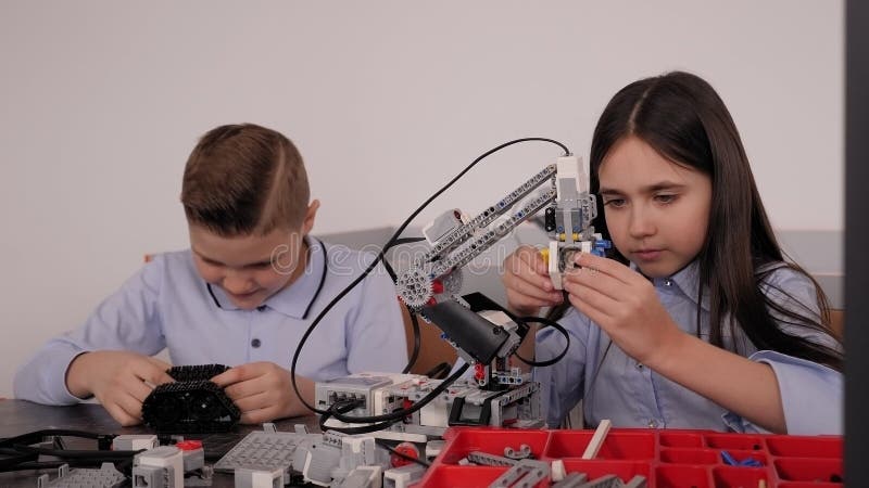 Children Makes a Robot from the Robotic Constructor at the Desk with ...