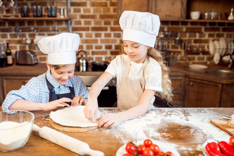 Children Making Pizza Dough with Pizza Ingredients on Foreground Stock ...