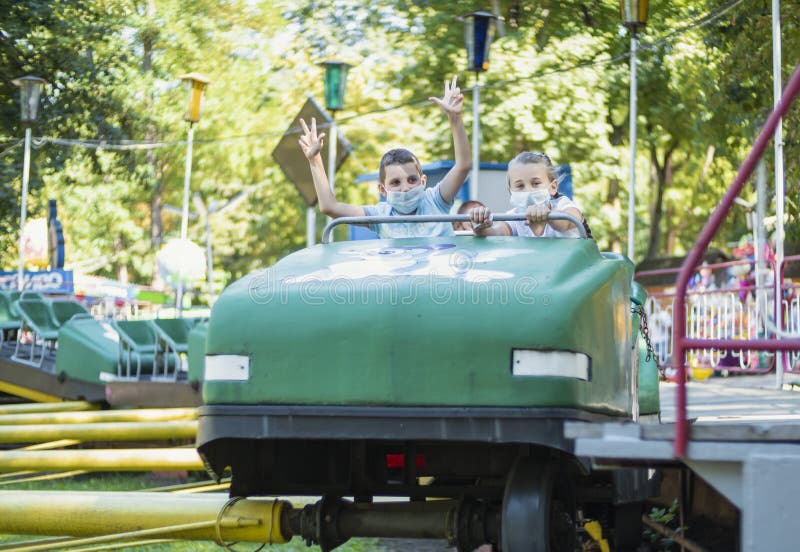 Children in Medical Masks Ride the Attraction Stock Image - Image of ...