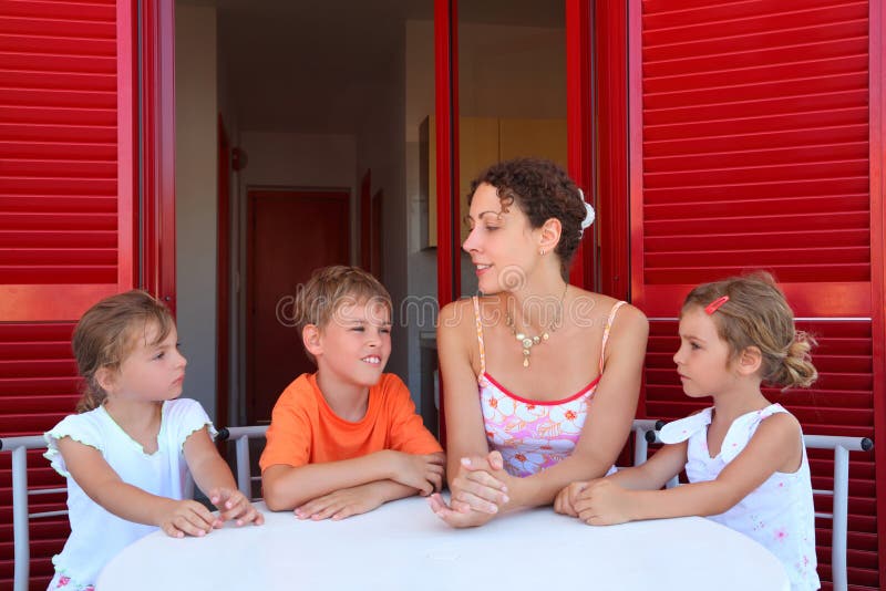 Children and Mother Sit on Verandah Round Table Stock Image - Image of ...