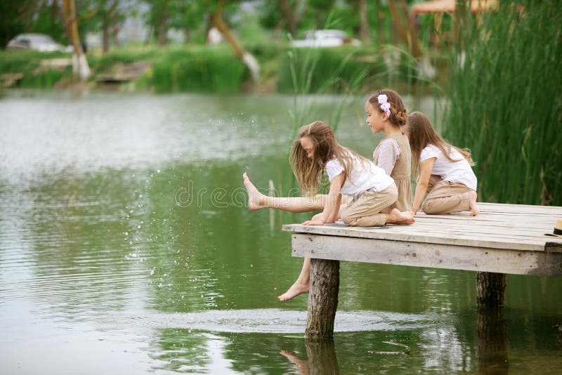 Children near pond stock image. Image of people, green - 40971265