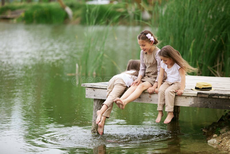 Children near pond stock photo. Image of friendship, little - 41346460