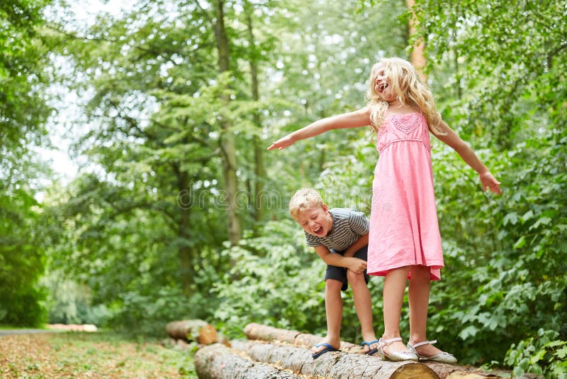 Children are Playing on Tree Trunks in the Forest Stock Photo - Image ...