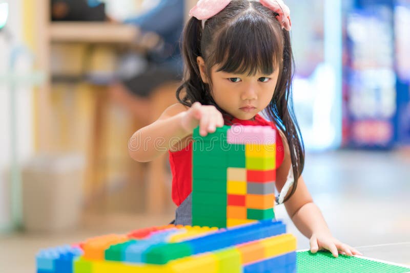 Children Play with Colorful Plastic Toys Blocks on Table Stock Photo ...