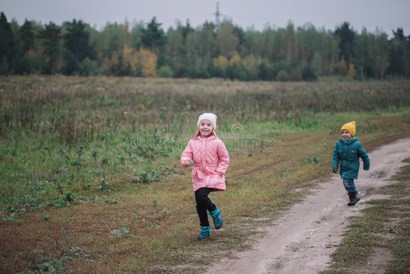 Children Play in the Field Running from Flying Drone Stock Photo ...