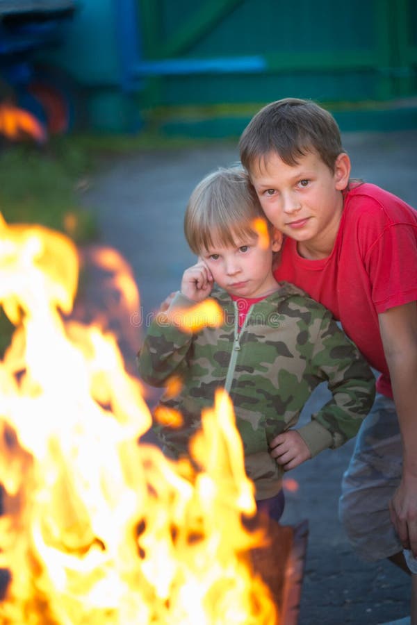 Children Play with Fire in the Grill Stock Photo - Image of outdoors ...