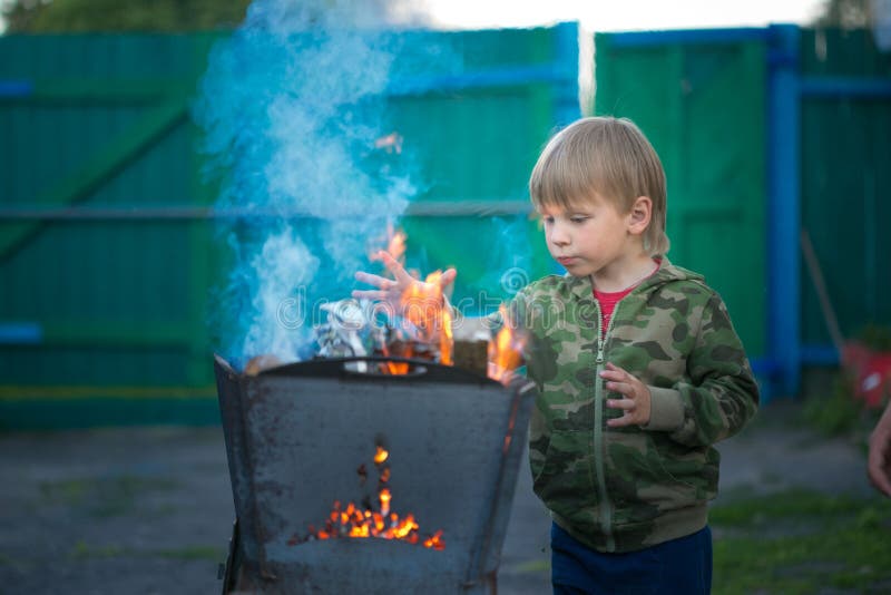 Children Play with Fire in the Grill Stock Photo - Image of girl, flame ...