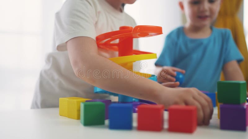 Children Play Game Launch Ball from a Slide on a Table in Kindergarten ...