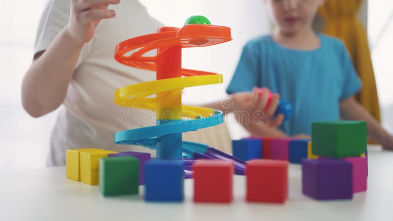 Children Play Game Launch Ball from a Slide on a Table in Kindergarten ...