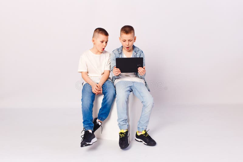 Children Play Games on Tablet. Children Hold a Tablet on a White ...