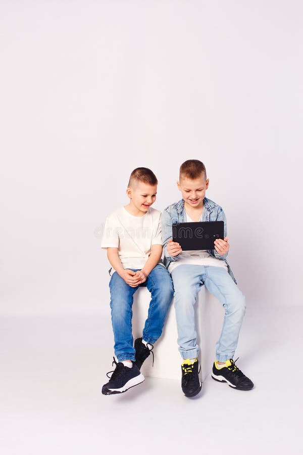 Children Play Games on Tablet. Children Hold a Tablet on a White ...