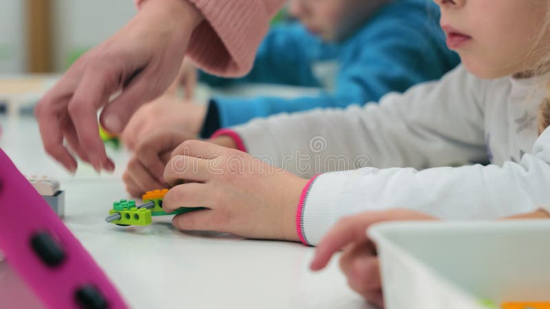 Children Play with Lego and Create Programmable Robots. Close-up of ...
