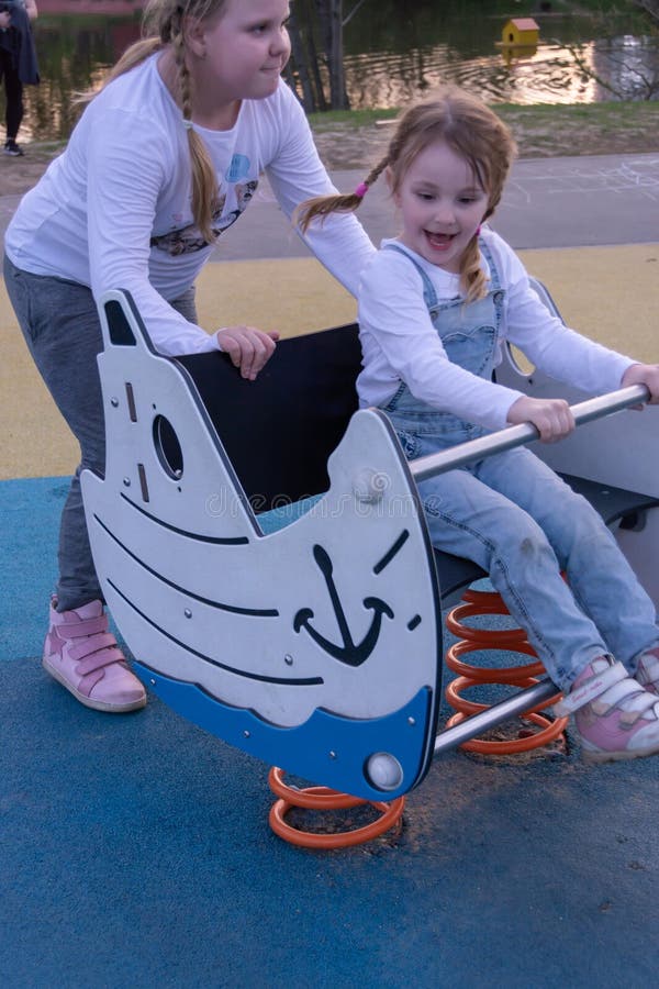 Children Play on a Modern, Secure Playground Stock Photo - Image of ...