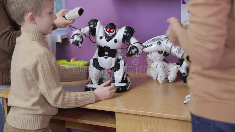 Kids playing with robots stock footage. Video of hands - 243700060