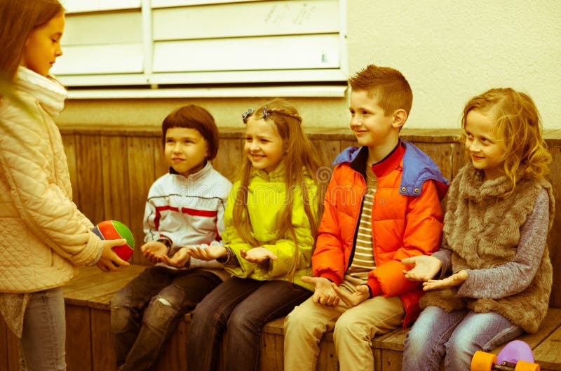 Children Playing with Ball on Bench Stock Photo - Image of bench ...