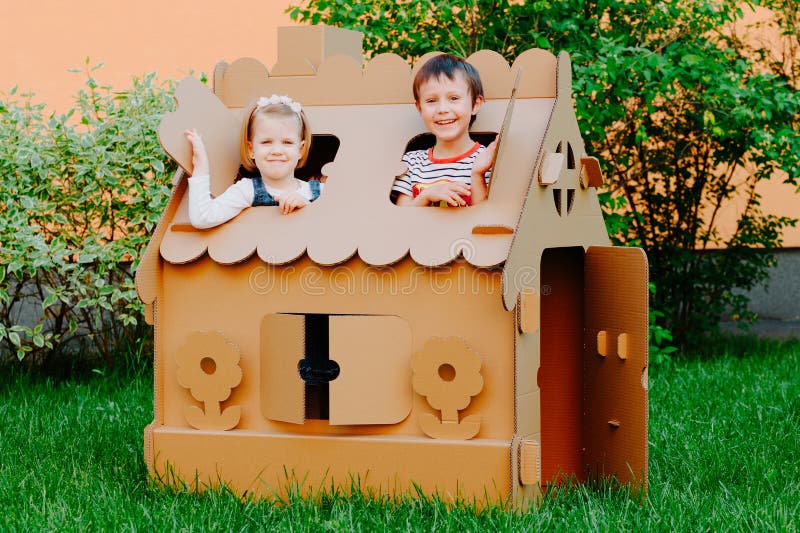 Children are Playing in Cardboard Kid House. Child Having Fun Outdoors ...