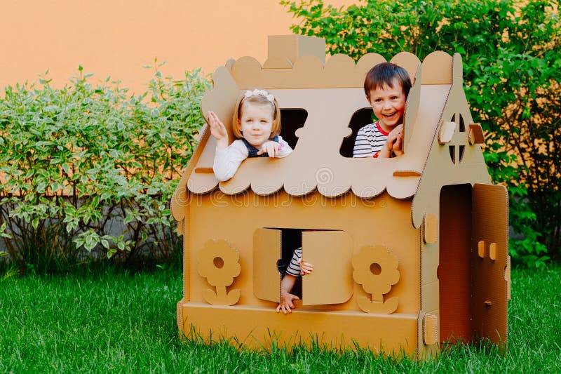 Children are Playing in Cardboard Kid House. Child Having Fun Outdoors ...