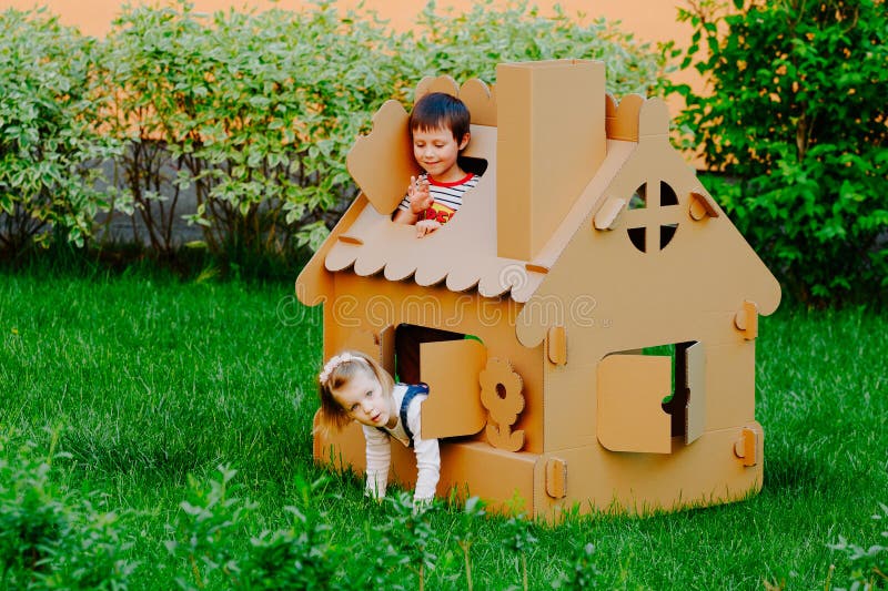 Children are Playing in Cardboard Kid House. Child Having Fun Outdoors ...