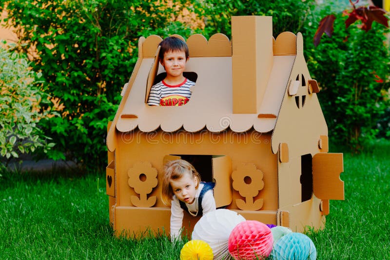 Children are Playing in Cardboard Kid House. Child Having Fun Outdoors ...