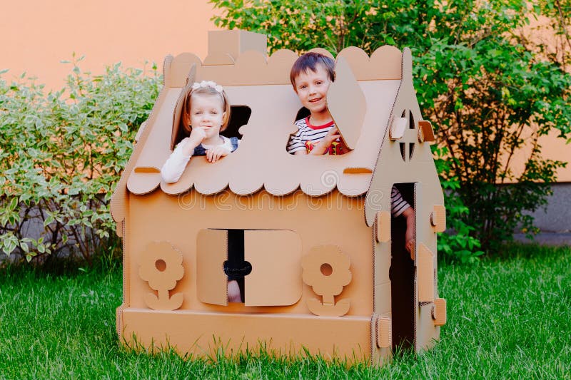 Children are Playing in Cardboard Kid House. Child Having Fun Outdoors ...